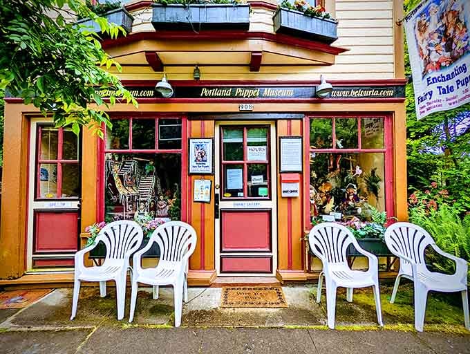 That cheerful storefront with the white plastic chairs is your gateway to puppet paradise in Portland.