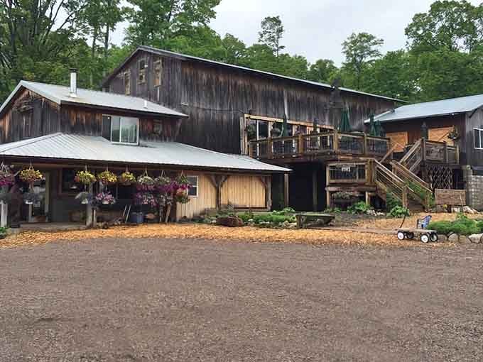 This rustic barn wrapped in flowers looks like it wandered off a Hallmark movie set and decided to start making wine.