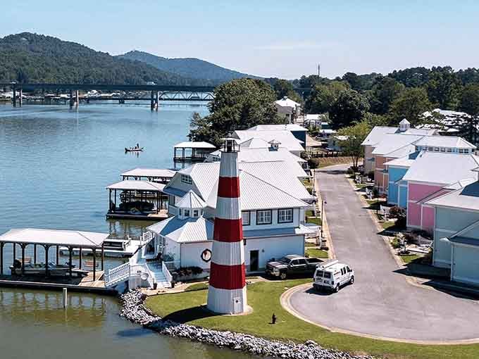 The lighthouse stands guard over waterfront homes where your biggest decision is which dock chair offers the best sunset view.