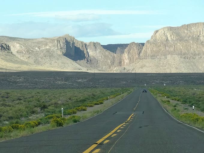 The open road stretches endlessly ahead, promising adventure in every mile of this stunning high desert landscape.
