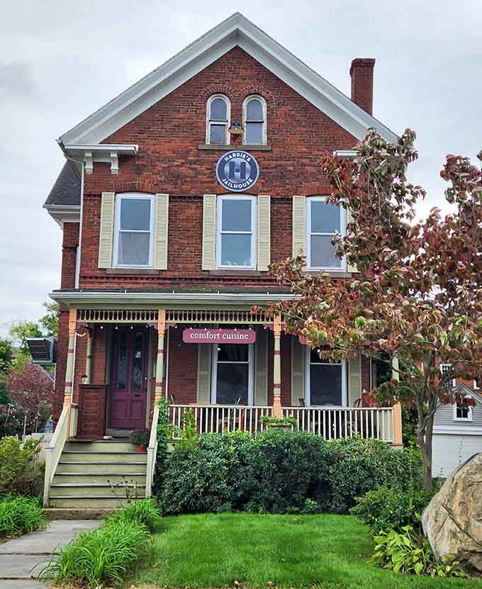 That charming Victorian brick facade with arched windows proves even former jailhouses deserve a second chance at happiness.