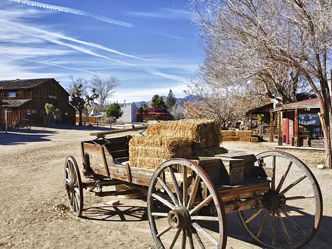 That vintage wagon and those hay bales aren't props, they're your first clue this desert town is delightfully real.