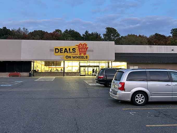 That cheerful yellow sign beckons like a beacon of bargain-hunting hope in the Waterbury landscape.