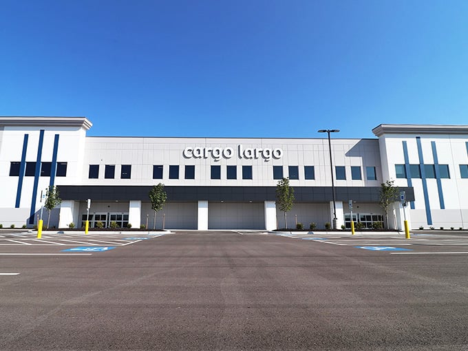 The modern facade might look fancy, but inside awaits a no-nonsense warehouse where savings matter more than architectural awards.