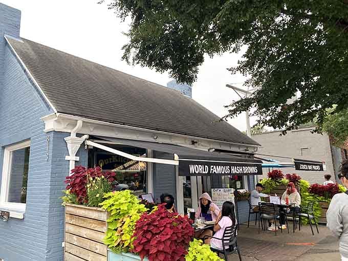 That charming blue cottage exterior practically begs you to come inside and eat your feelings in the best way possible.