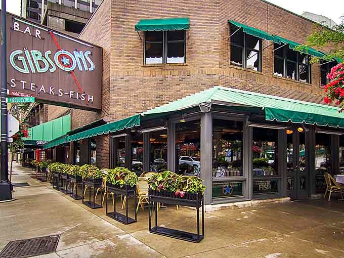 Enjoy a lovely afternoon patio scene with vibrant greenery and friendly service at this iconic Chicago steakhouse location.