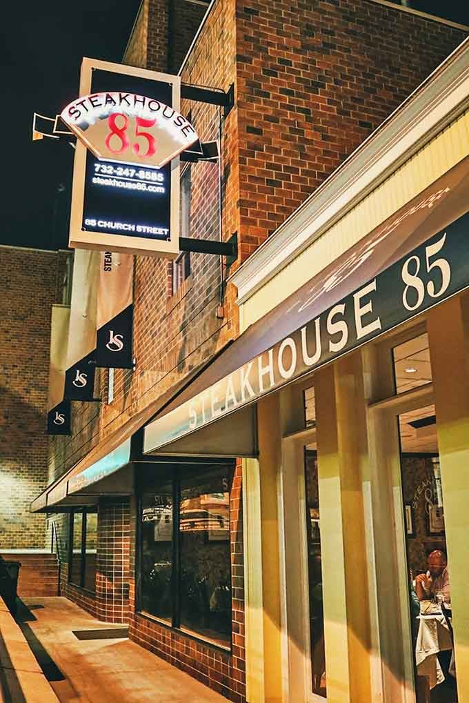 That iconic sign glowing against the brick tells you everything you need to know: serious food happens here, folks.