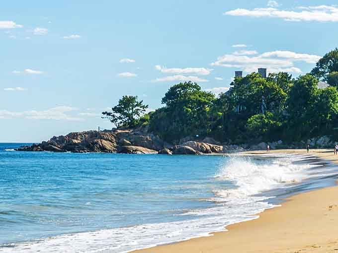 Golden sand meets sapphire water where rocky outcroppings frame this crescent of coastal perfection beautifully.
