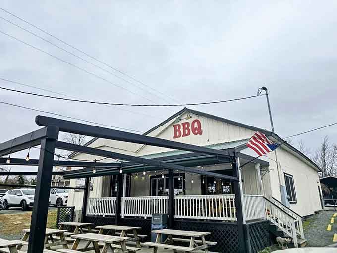 That humble white building with the big red BBQ letters is your gateway to smoked meat paradise.