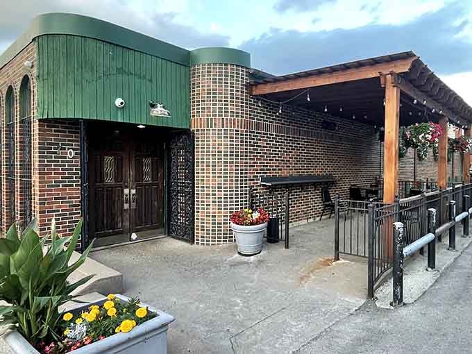 That charming brick exterior with cheerful flowers whispers "neighborhood gem" louder than any billboard ever could.