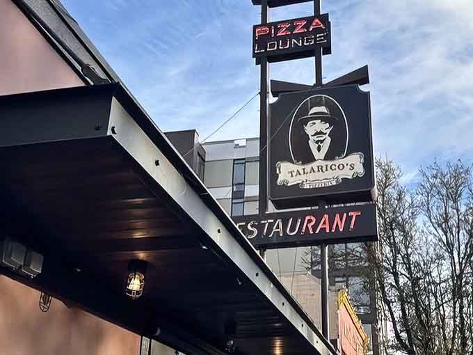 That vintage sign promises pizza lounge magic, and trust me, the interior delivers on every delicious word.