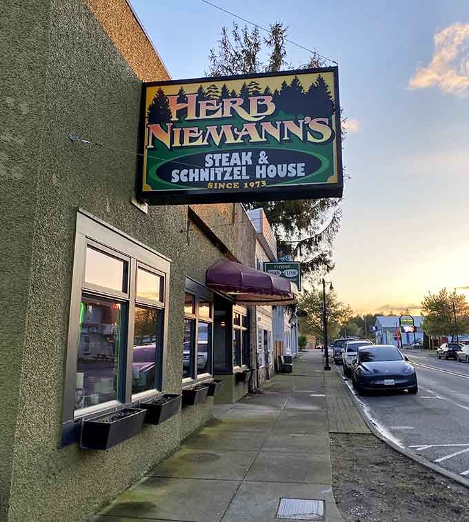 That vintage sign glowing against the evening sky promises serious steak and schnitzel since 1973.