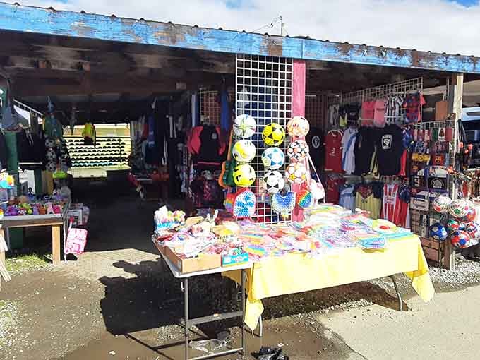 Colorful toys and sporting goods spill out from this outdoor booth, showing the incredible variety you'll find around every corner.