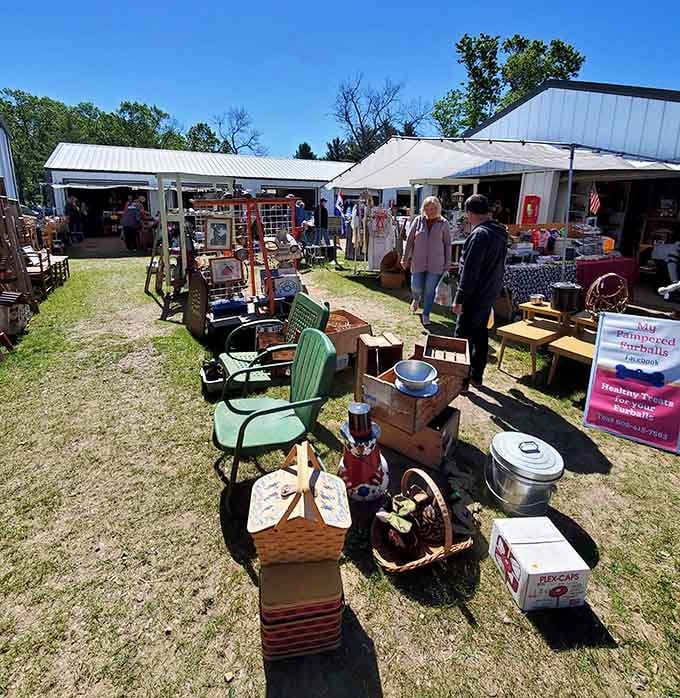 Vintage furniture sprawls across the grass like a living room exploded in the best possible way.