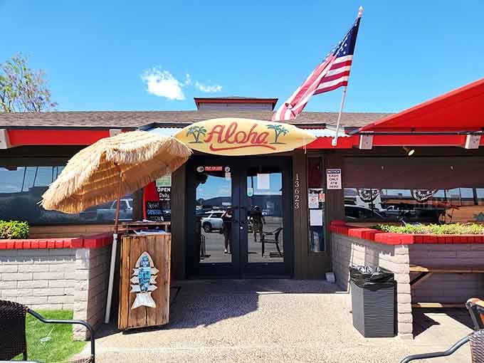 That "Aloha" sign isn't kidding around&mdash;this tiki umbrella entrance promises tropical breakfast vibes in the desert.