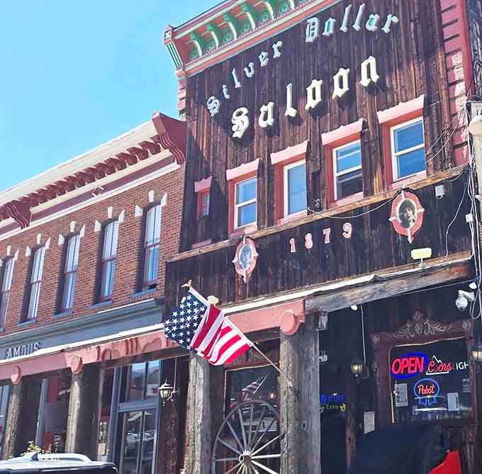 That weathered wooden facade has witnessed more Colorado history than most textbooks could ever capture in words.