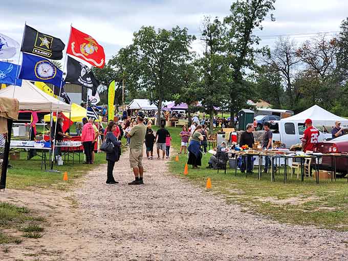 Flags wave overhead as treasure hunters navigate rows of possibilities on this perfect market day.