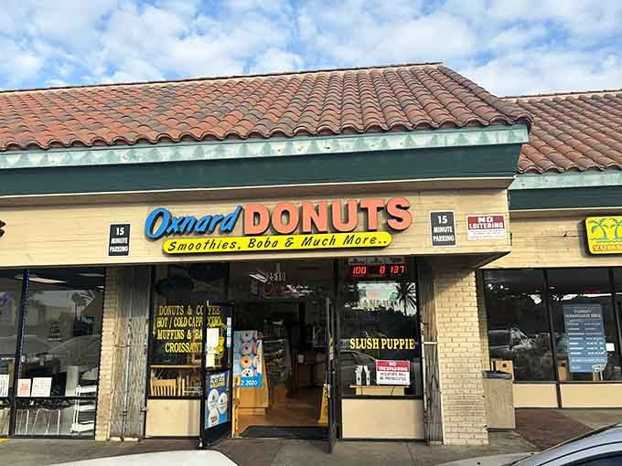 That cheerful storefront sign promises smoothies, boba, and "much more," which is donut-speak for pure happiness.
