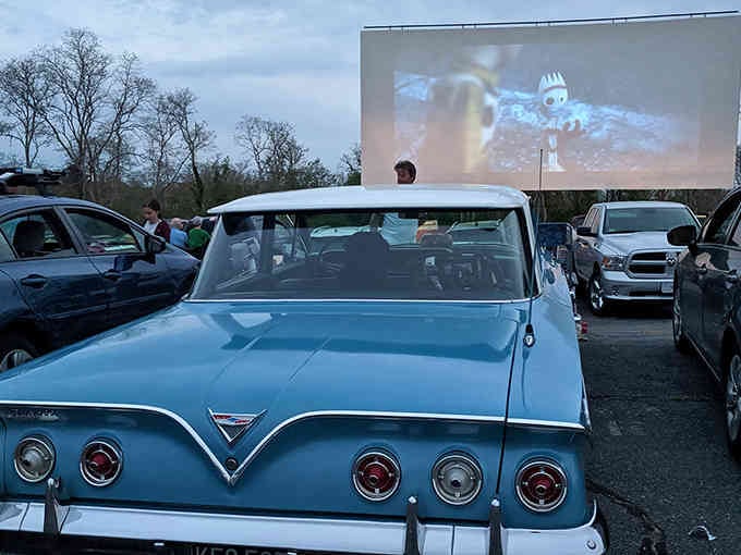 That vintage blue beauty knows what's up: prime parking for maximum movie magic under the stars.