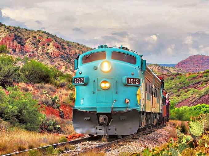 That turquoise locomotive against red rocks creates a color combination that would make any artist weep with joy.