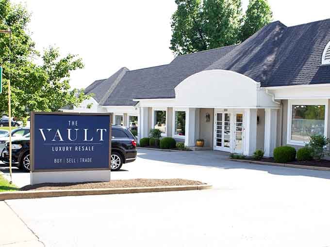 That elegant navy sign promises luxury resale, and the pristine white building behind it absolutely delivers on every word.