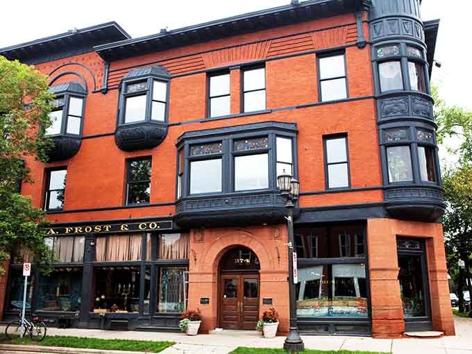 That burnt orange Victorian facade with black trim looks like it wandered over from a European postcard and decided to stay.
