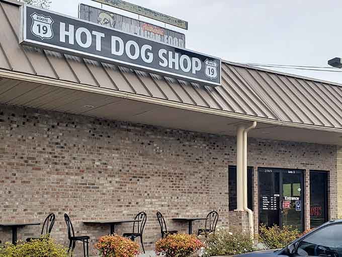 That metal roof and brick facade hide some seriously good eating just beyond those welcoming doors.