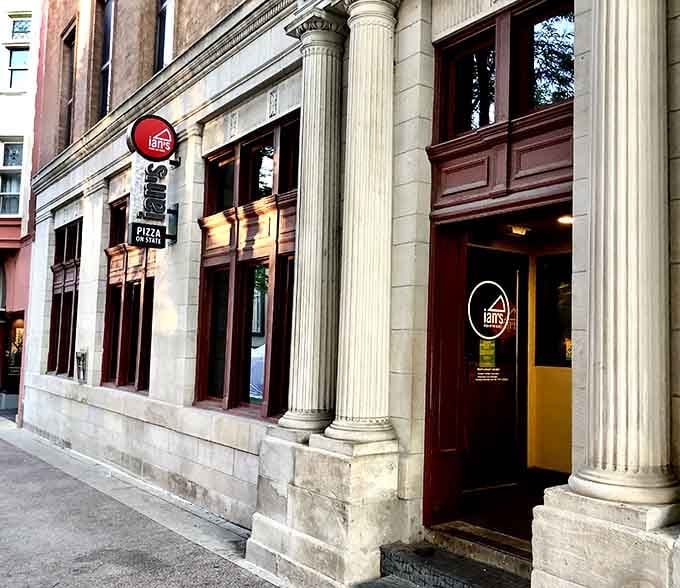Those classic columns frame the entrance to pizza paradise on one of Madison's most iconic streets.