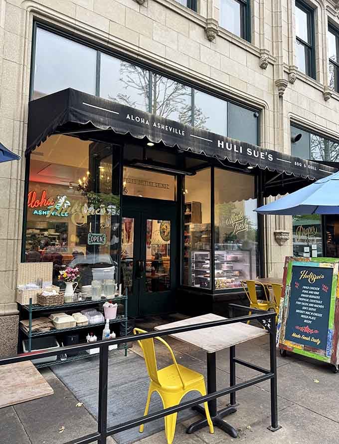 That "Aloha Asheville" awning isn't lying, this storefront promises a tropical escape with serious barbecue credentials.