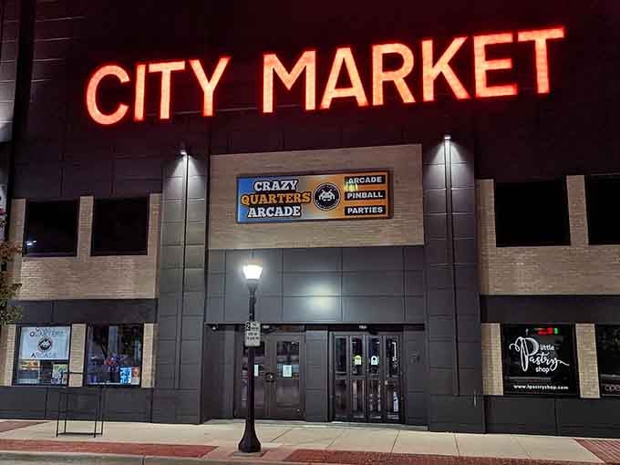 The glowing City Market sign beckons like a lighthouse guiding you to retro gaming paradise in downtown Bay City.
