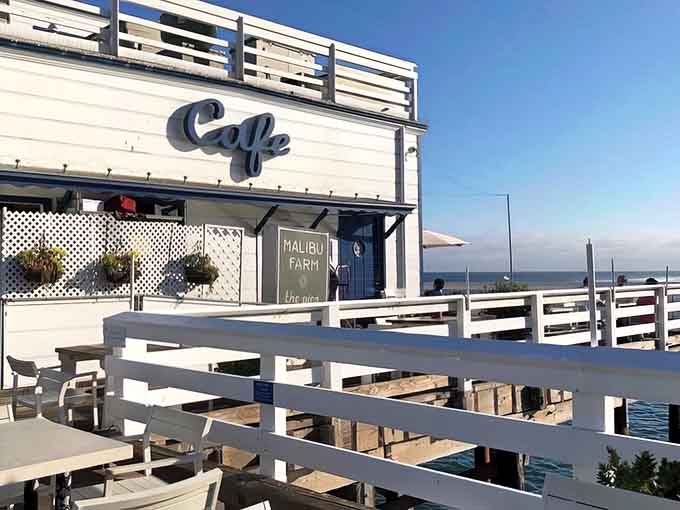 The iconic white building at pier's end beckons like a lighthouse for hungry souls seeking coastal bliss.