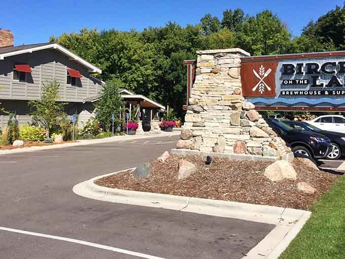 That stone pillar and welcoming entrance promise something special waiting just beyond those doors and flowering planters.