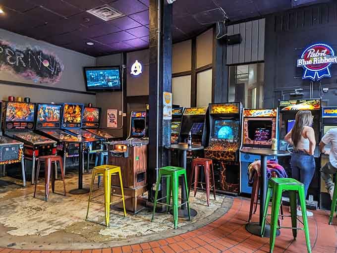 Colorful stools invite you to settle in for serious gaming sessions fueled by nostalgia and adult beverages.