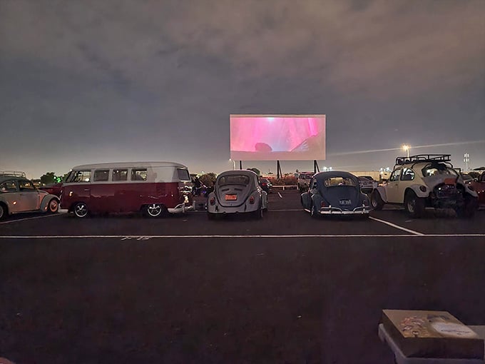 Classic cars lined up under dramatic skies create a scene straight out of American Graffiti's opening credits.