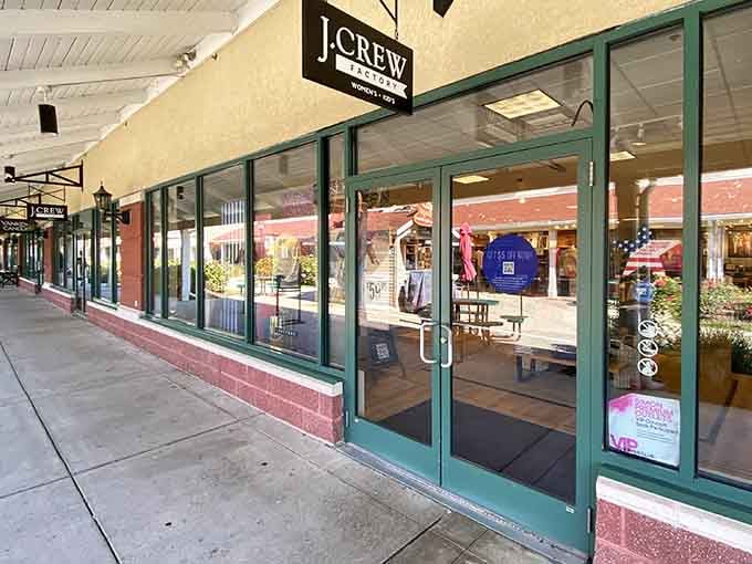 The J.Crew storefront beckons with promises of preppy perfection without the country club membership fees required.