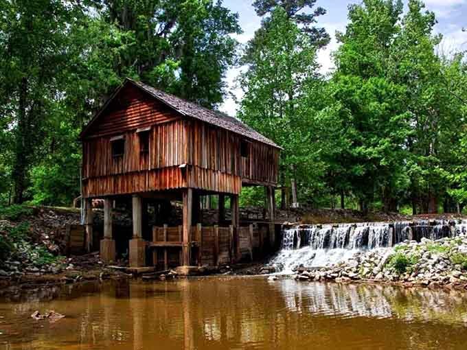 This weathered mill standing over flowing water looks like it wandered straight out of a Southern postcard's daydream.