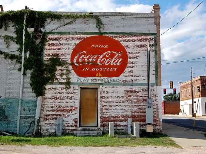 That vintage Coca-Cola mural whispers stories from when a nickel bought happiness in a glass bottle.