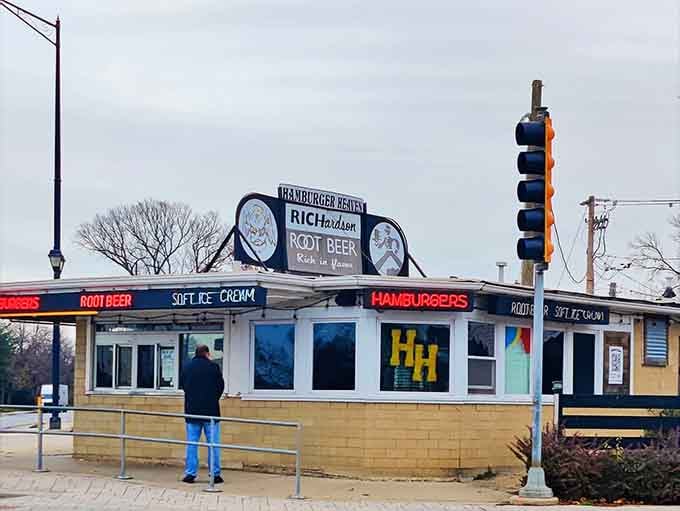 Classic walk-up windows and outdoor seating promise burgers big enough to require architectural planning before eating.