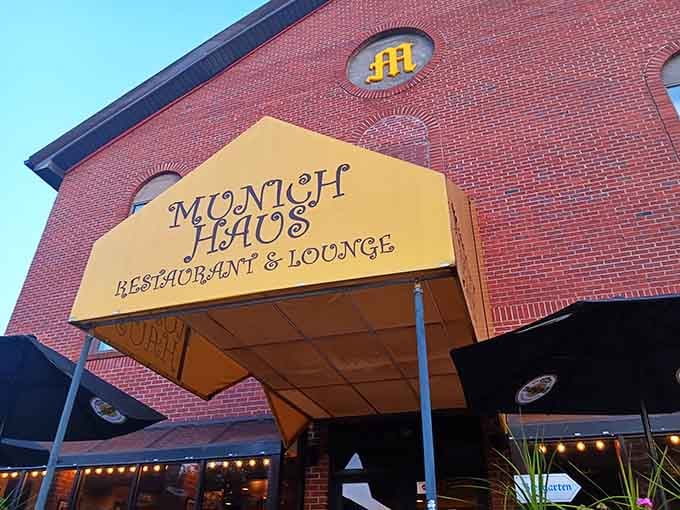 That cheerful yellow awning beckons like a Bavarian beacon, promising schnitzel and gem&uuml;tlichkeit just beyond the door.