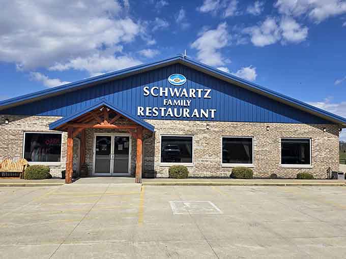 That blue metal roof and stone facade promise something better than your average roadside stop, and they deliver.