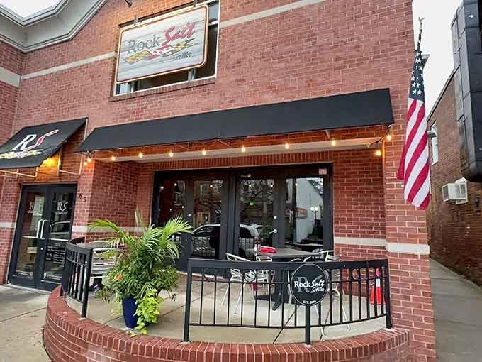That brick facade and welcoming patio practically whisper "come on in, we've been waiting for you."