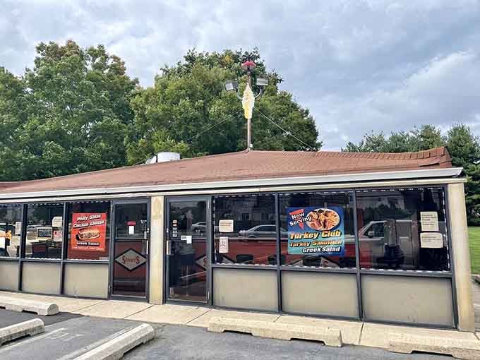 Classic drive-in architecture that's been serving joy since before smartphones ruined dinner conversations everywhere.