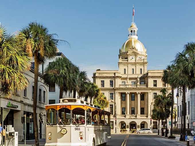 City Hall stands proud behind palm trees while trolleys roll past, blending Southern charm with practical transportation.