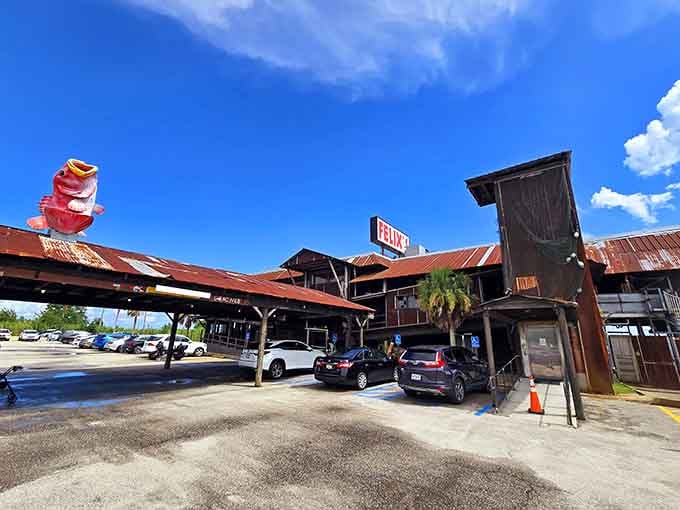 That cheerful pink shrimp mascot perched on the rustic roof tells you everything: this place doesn't take itself too seriously.