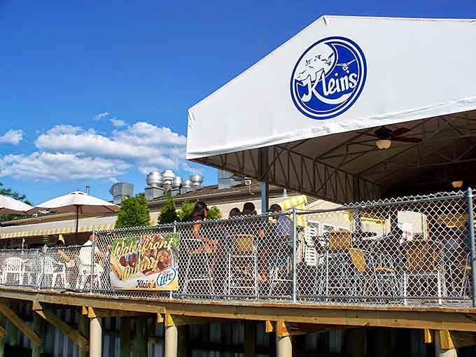 The Riverfront Bar & Grill sign promises waterside dining that'll make you forget every landlocked meal you've ever eaten.