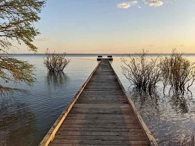 That wooden pier stretching into Lake Phelps looks like the gateway to another world entirely.