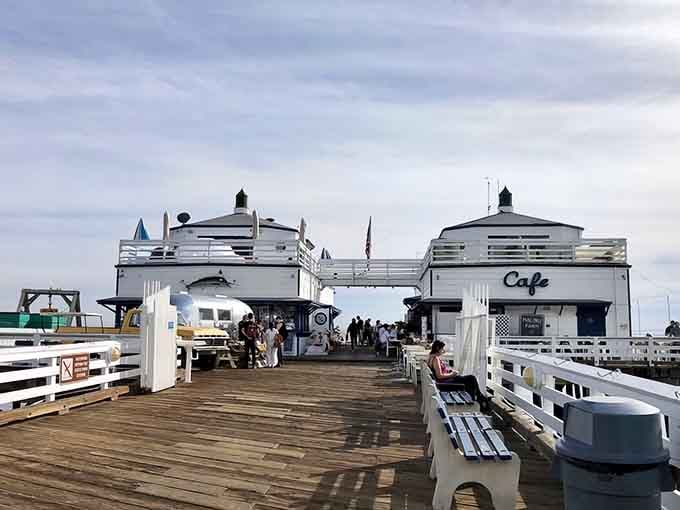 The iconic white building at pier's end beckons like a lighthouse for hungry souls seeking coastal bliss.
