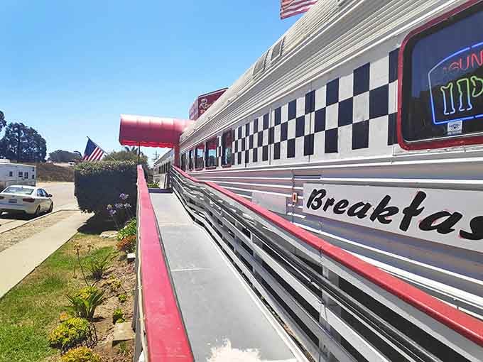 That checkered racing stripe screams "Happy Days" louder than the Fonz ever could on this gleaming train car diner.