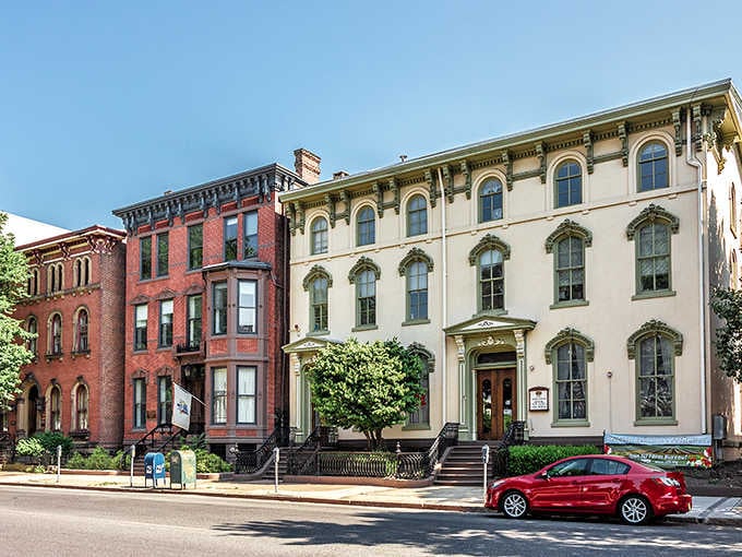 Historic rowhouses line streets where affordability meets architectural beauty, proving charm doesn't require a trust fund.