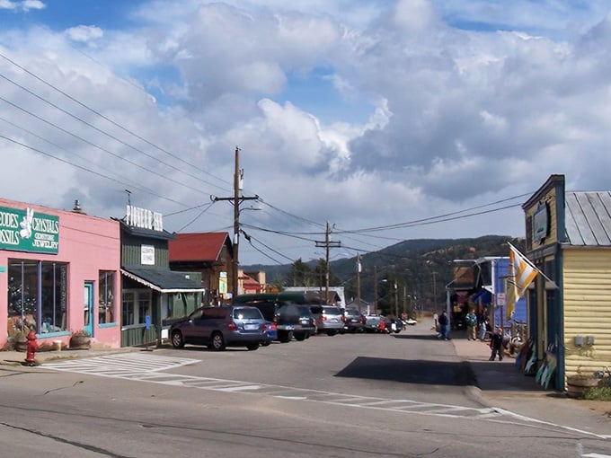 Main street painted in colors that would make a box of crayons jealous, backed by mountains that steal the show.